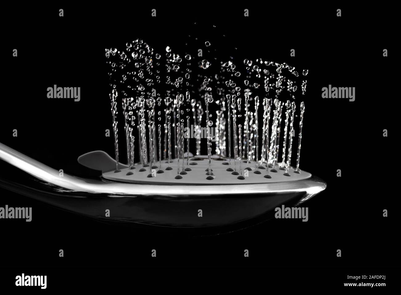 Water jets from the shower directed upwards. On a dark background Stock ...