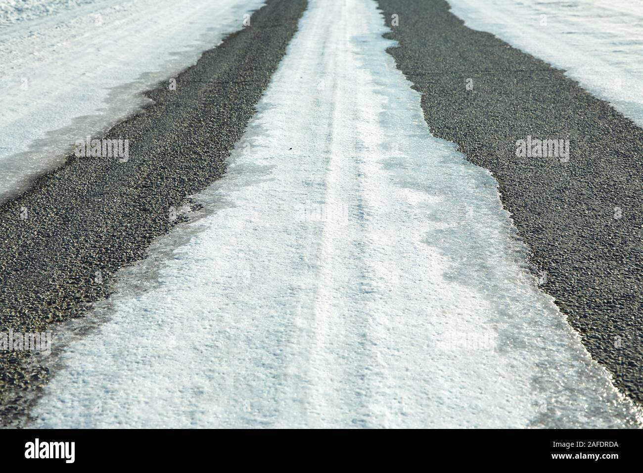 winter asphalt road covered ice crust. snow covered driveway Stock ...