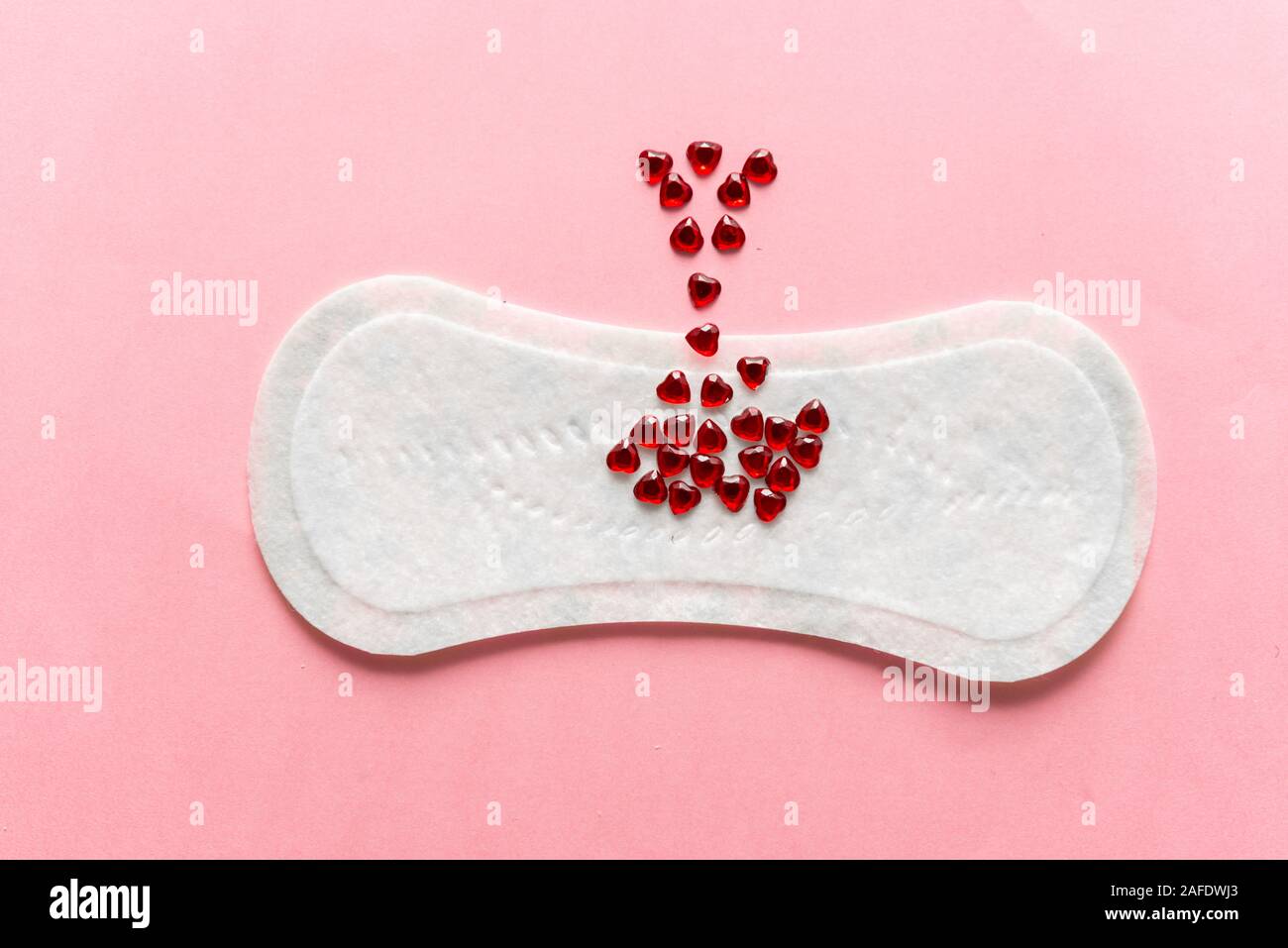 Feminine hygiene pad on a pink background. Concept of feminine hygiene ...