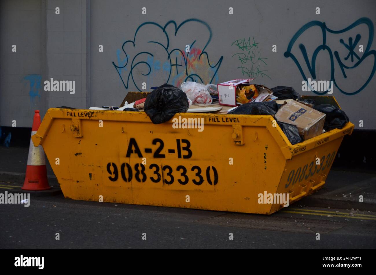 Overflowing rubbish skip hi-res stock photography and images - Alamy