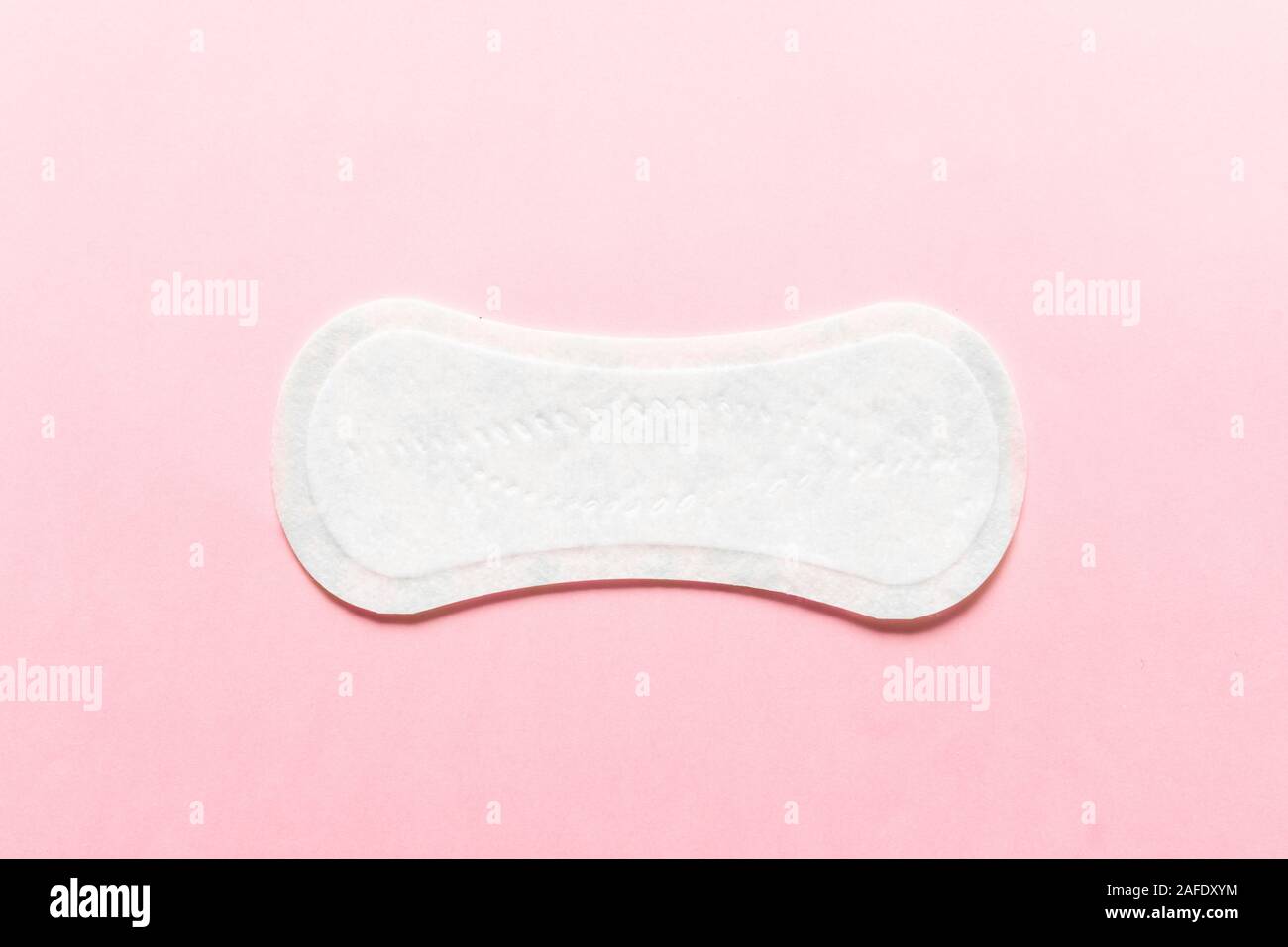 Feminine hygiene pad on a pink background. Concept of feminine hygiene ...