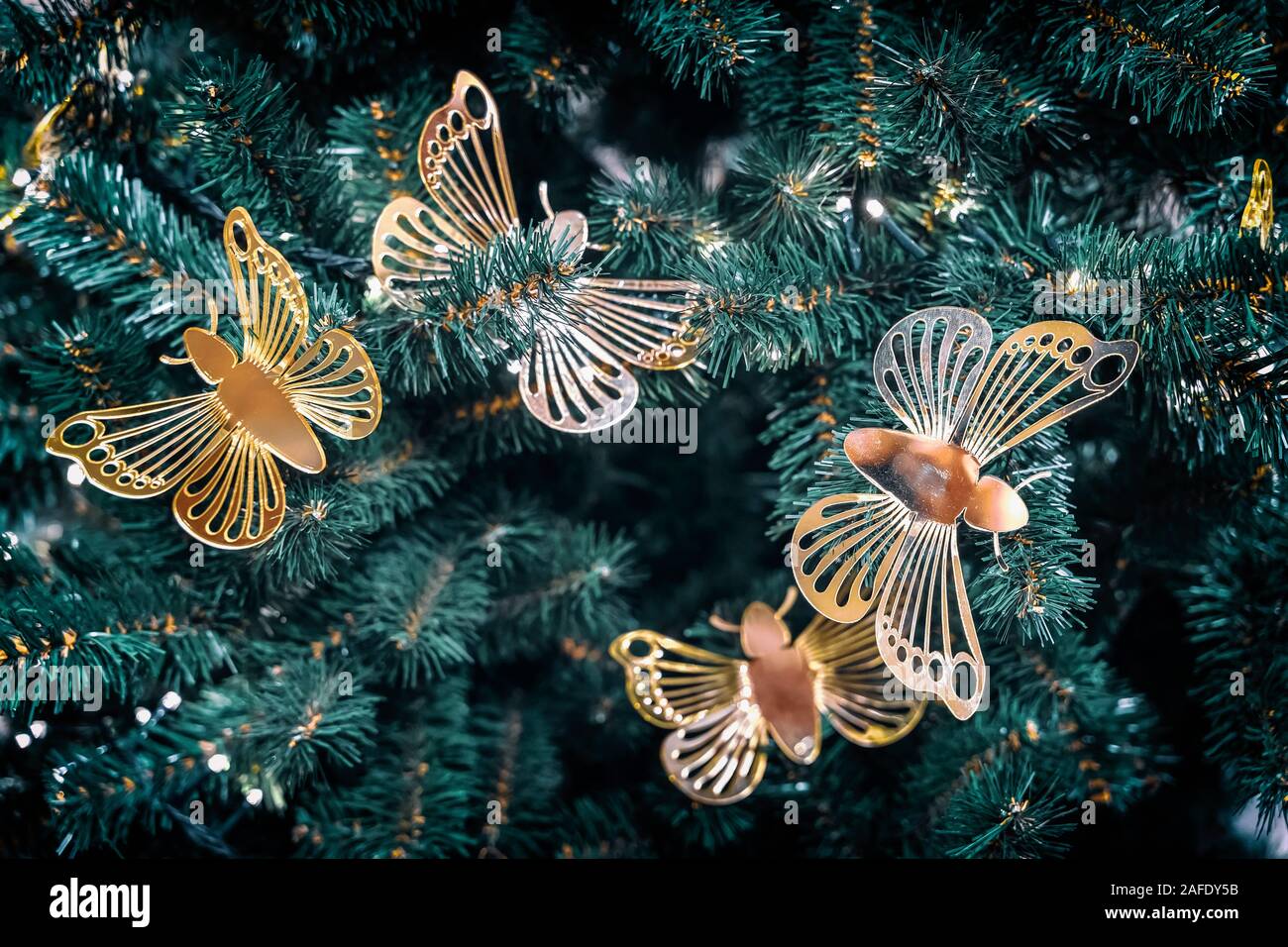 Christmas tree with decorations. Fir tree with golden butterflies ...