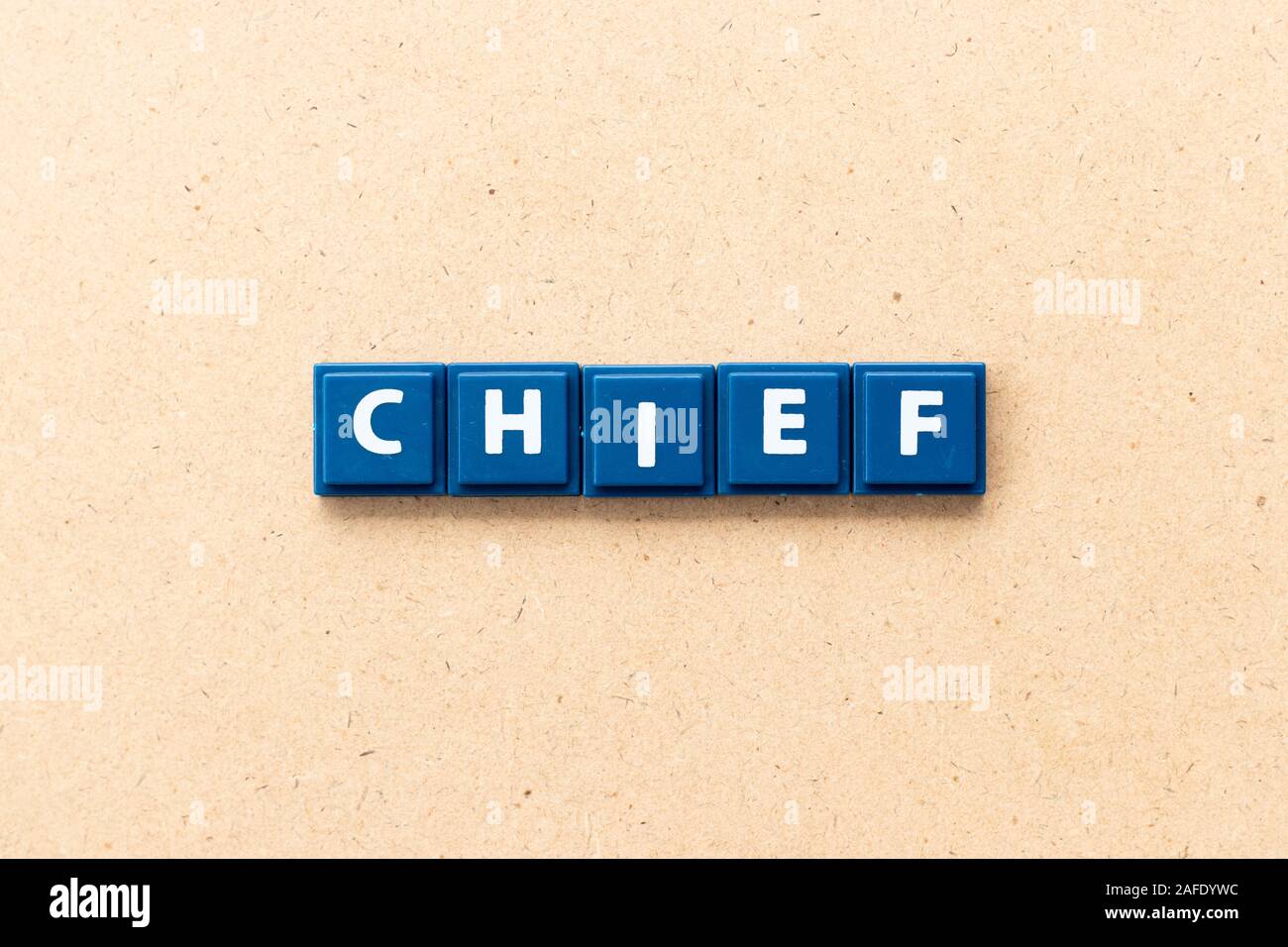 Tile letter in word chief on wood background Stock Photo - Alamy
