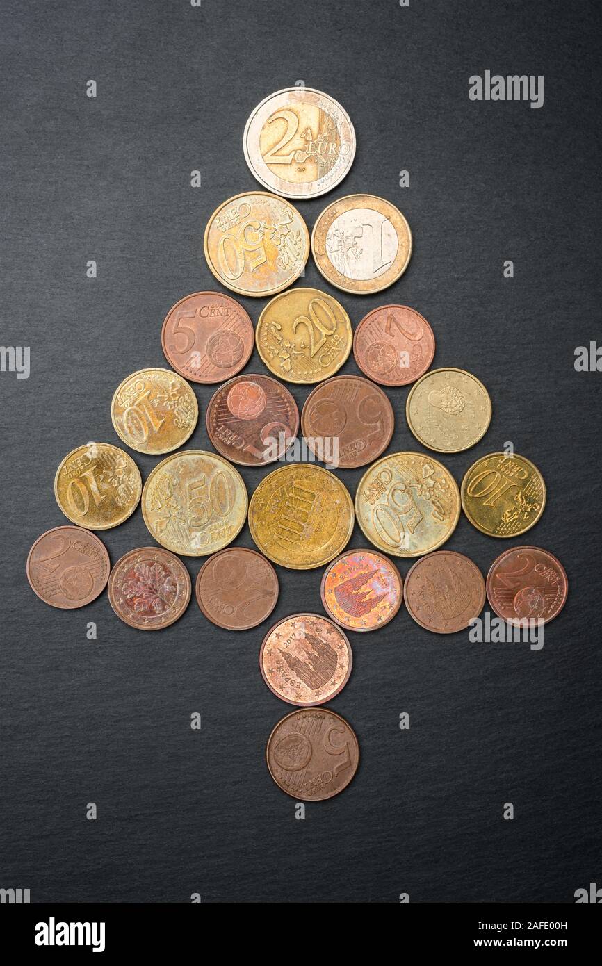 Christmas tree made out of Euro coins on dark black slate plate ...