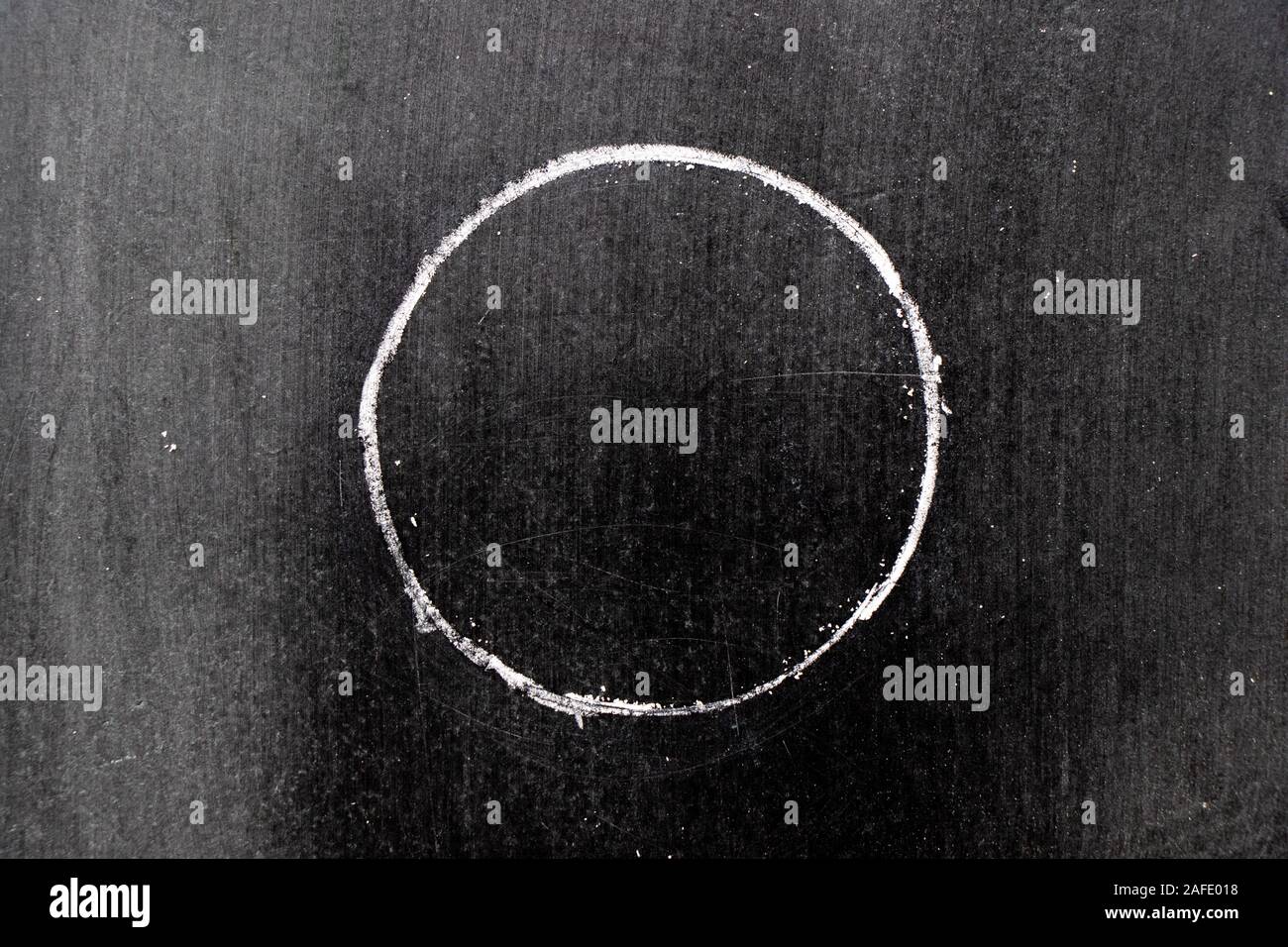 White chalk hand drawing in circle or round shape on black board ...