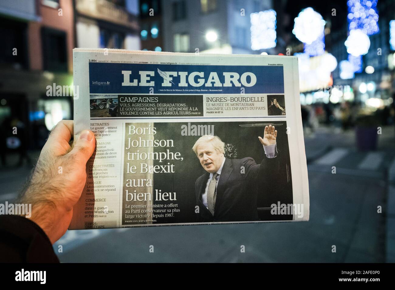 Paris, France - Dec 14, 2019: Man holding near press kiosk Le Figaro ...