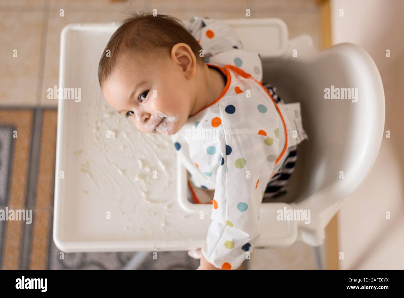 A Little baby eating her dinner and making a mess Stock Photo - Alamy