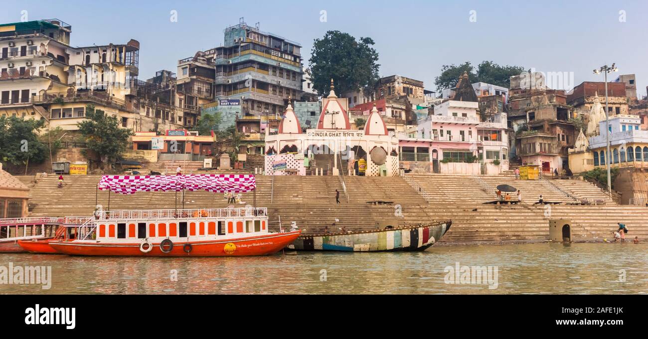 Panorama of historic buildings and boats at the Scindia Ghat in ...