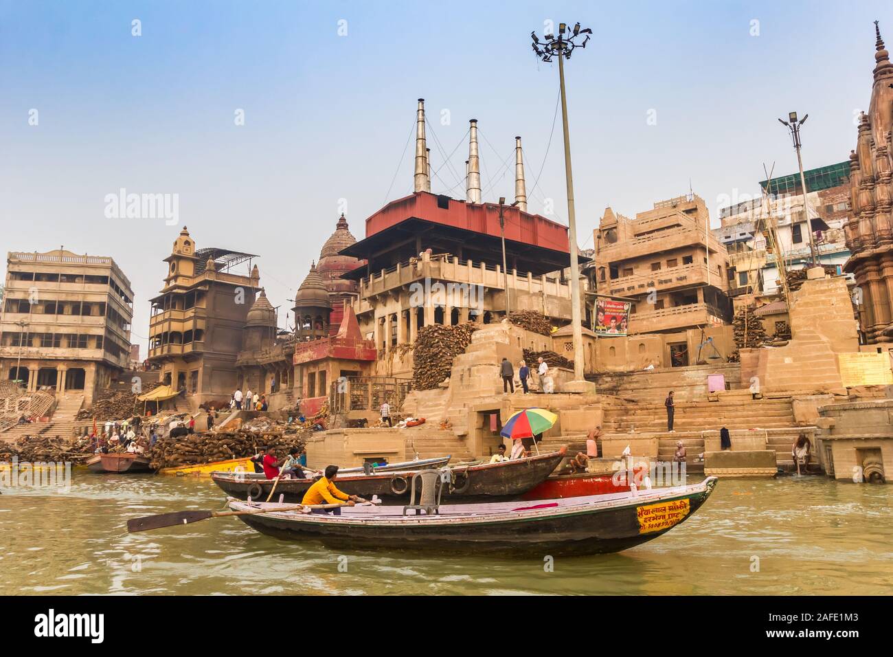 Boats going by the cremation ghat in Varanasi, India Stock Photo - Alamy