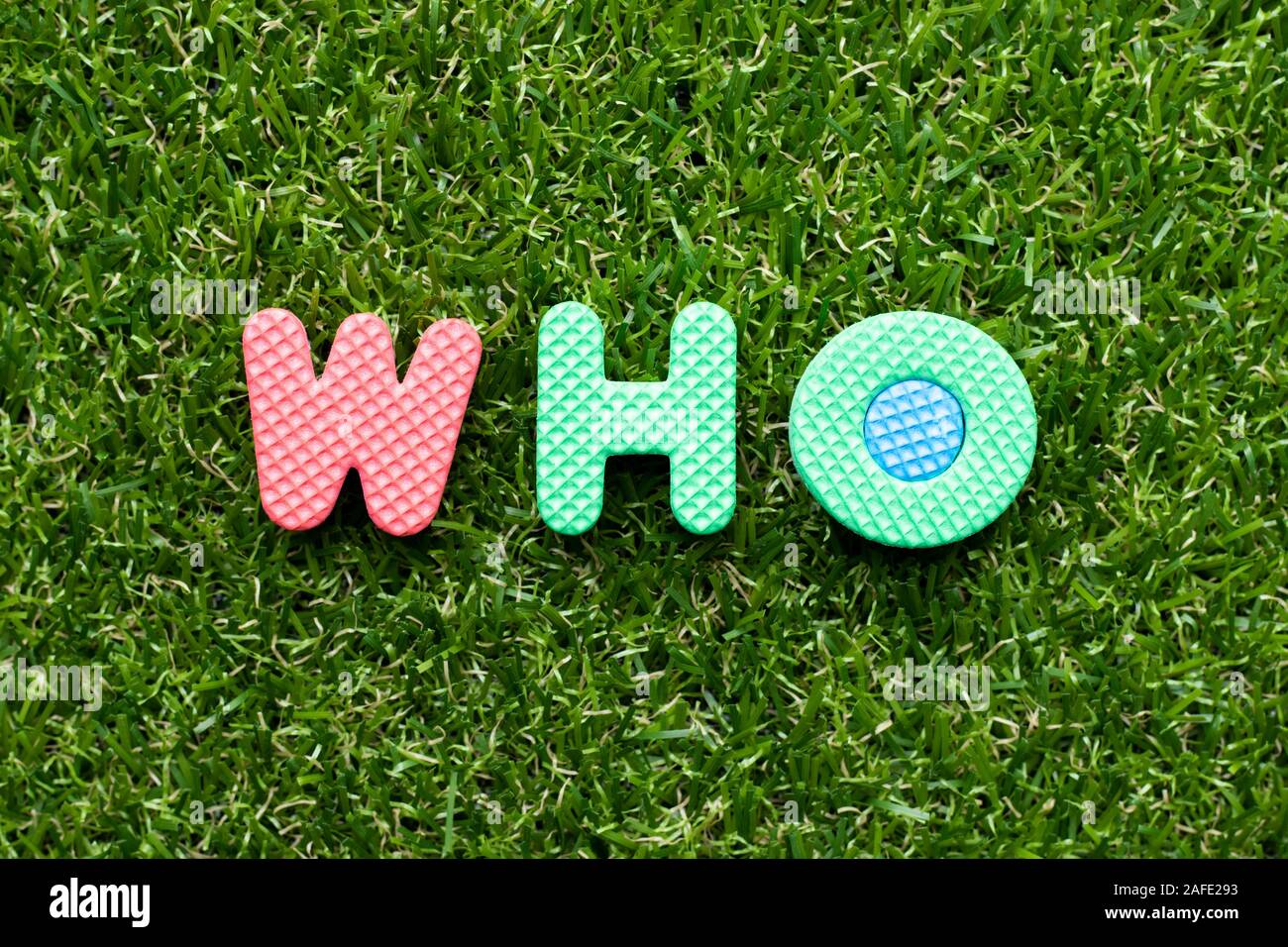 Toy foam letter in word who on green grass background Stock Photo - Alamy