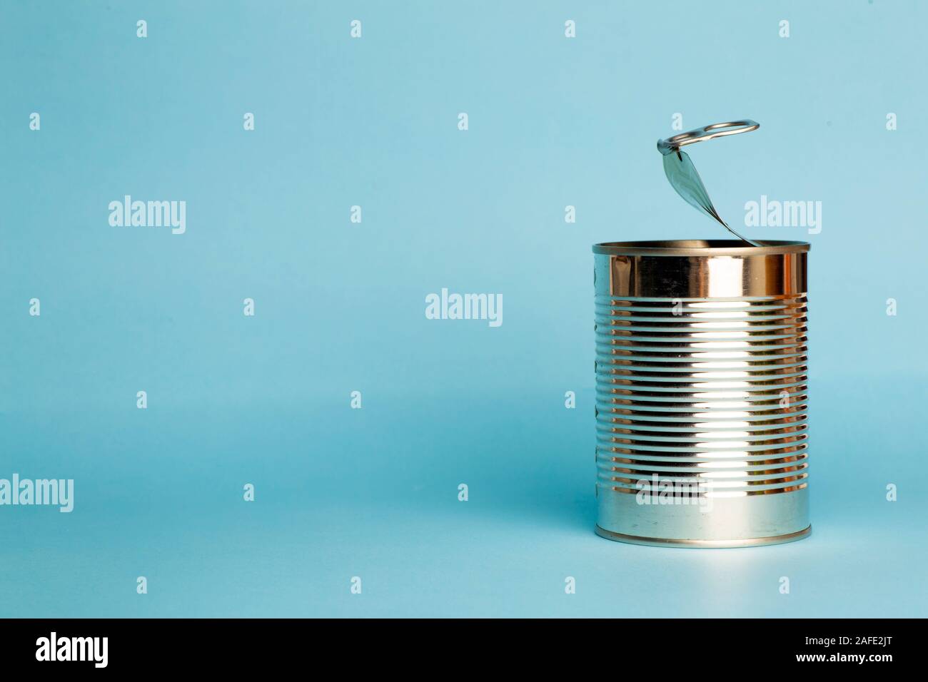 Tin can on a blue background. Recycling of metal and environmental ...