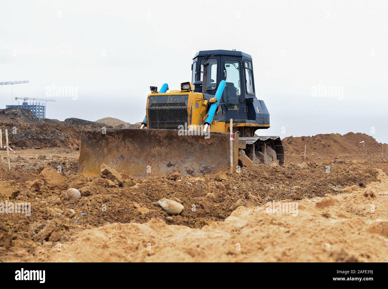 Bulldozer during of large construction jobs at building site. Land ...