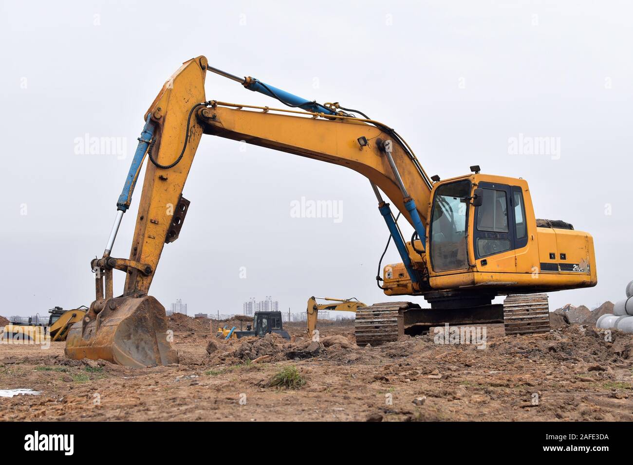 Excavator with a large iron bucket on a construction site during road ...