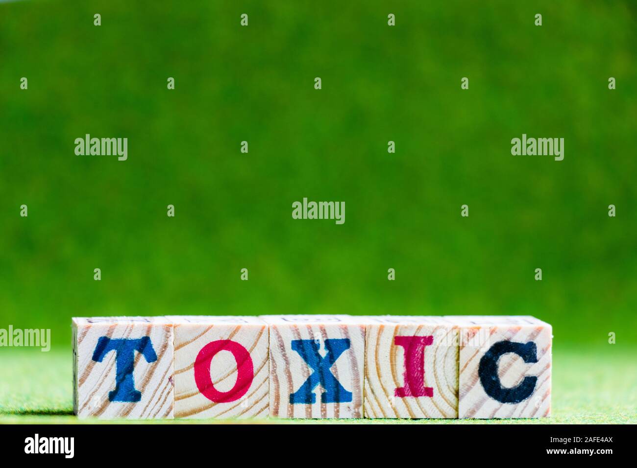 Letter block in word toxic on artificial green background Stock Photo ...