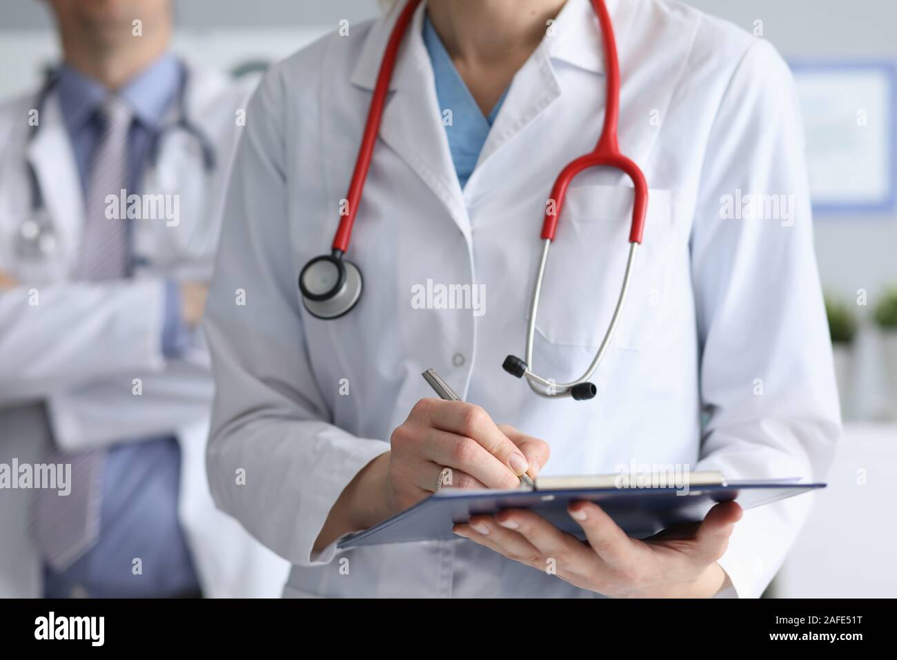 Doctor signing documents Stock Photo - Alamy
