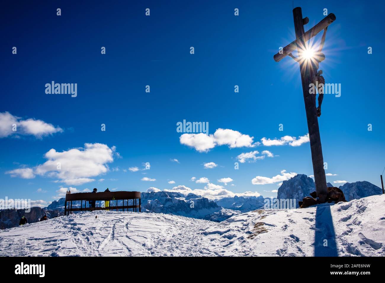 An old crucified Christ on the top of the mountain in italian alps ...