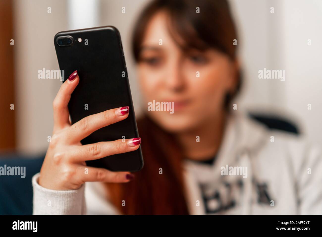 Young girl sending messages Stock Photo - Alamy