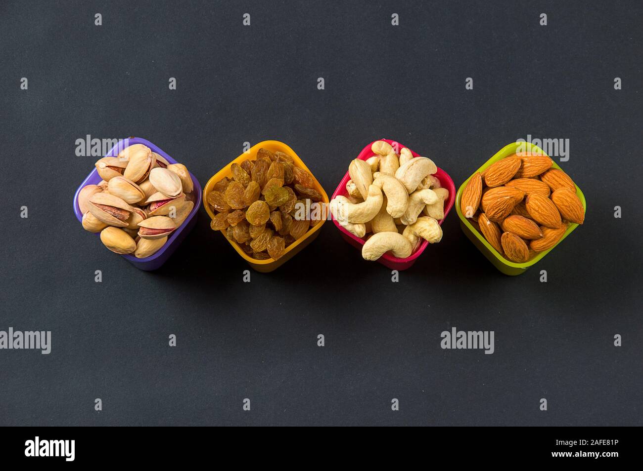 Healthy Mix Dry Fruits and Nuts on dark background. Almonds, Pistachio ...