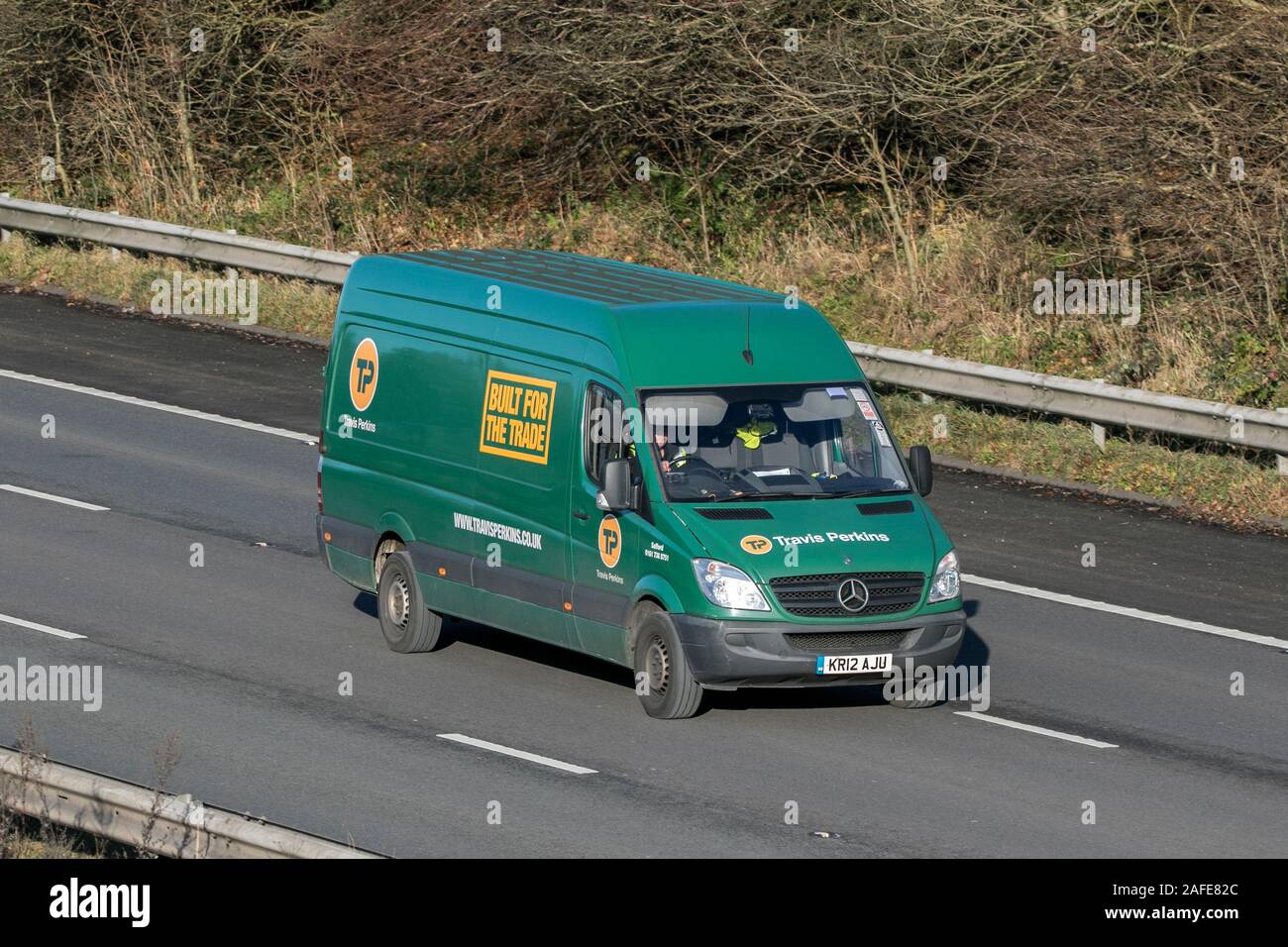 Green Travis & Perkins Mercedes Benz van driving on the M61 near ...