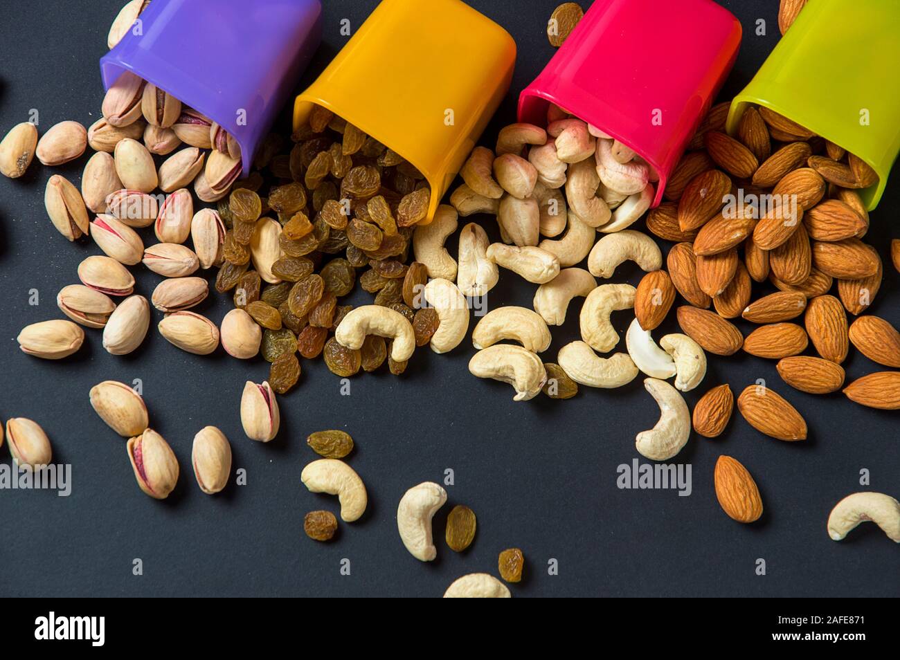 Healthy Mix Dry Fruits and Nuts on dark background. Almonds, Pistachio ...