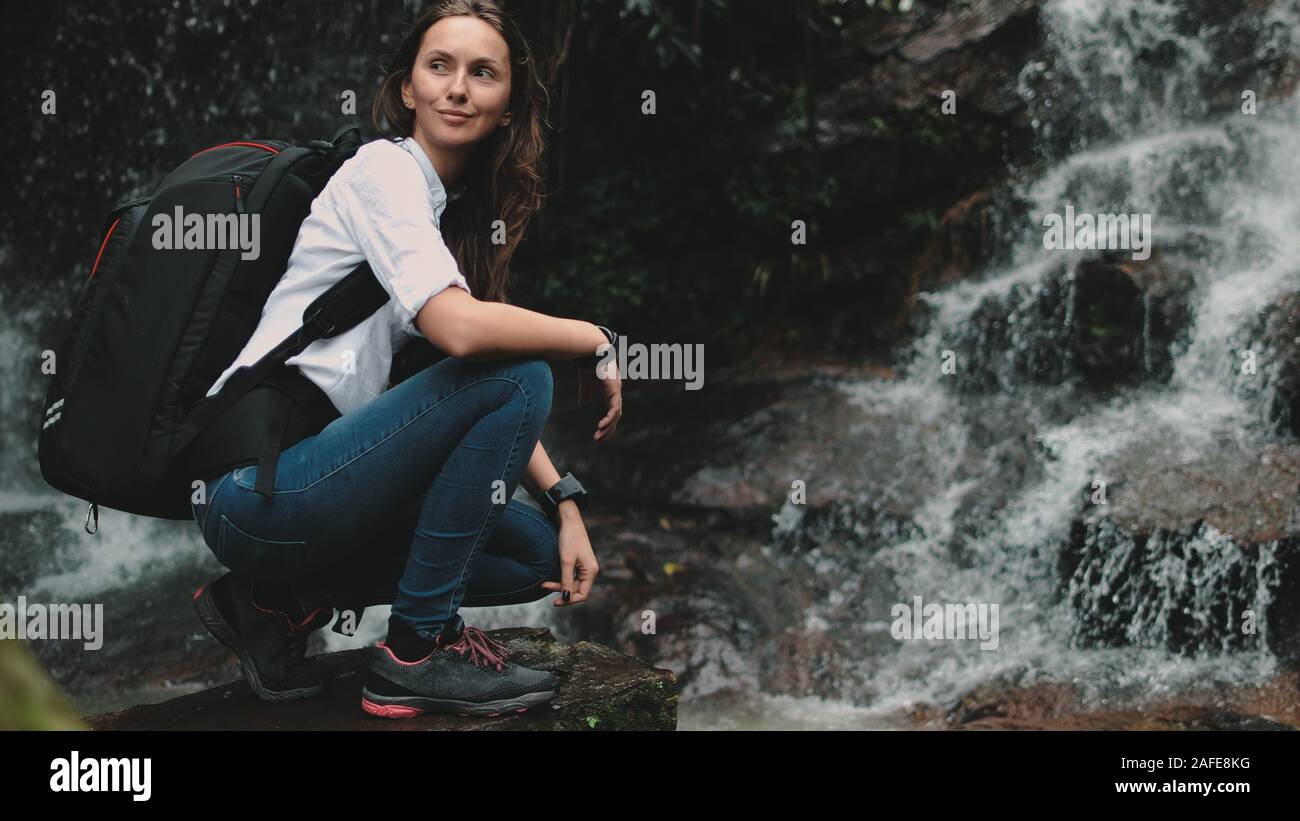 Female Hiker Crouch near Wild Splashing Waterfall. Caucasian Girl ...