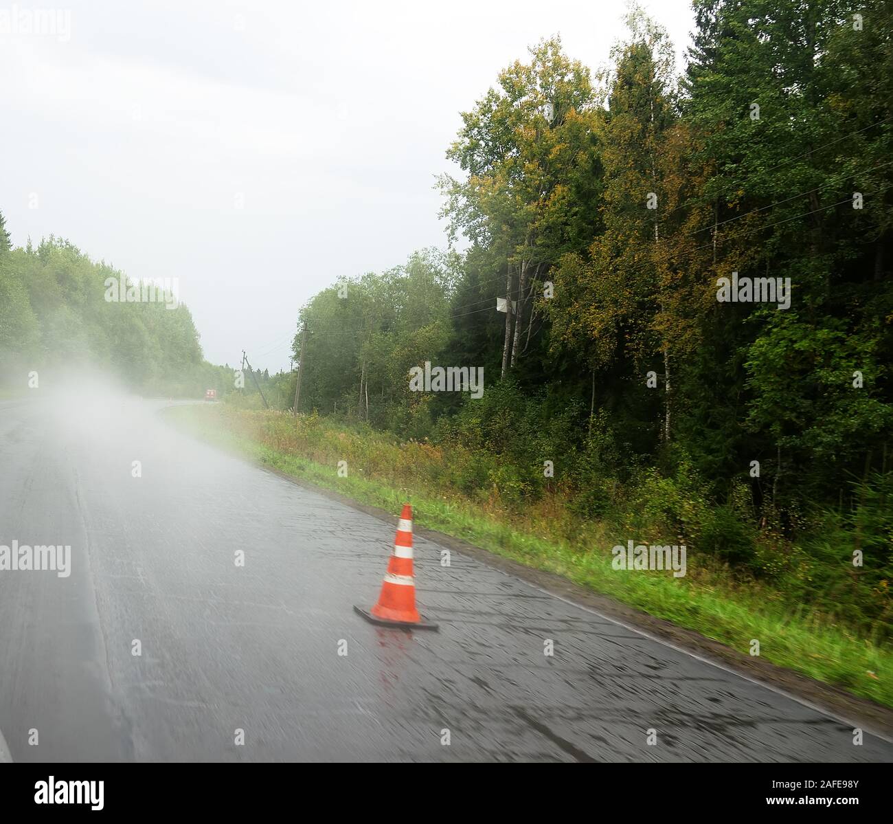 Road-building. Fresh laid asphalt watered, water evaporation over new ...