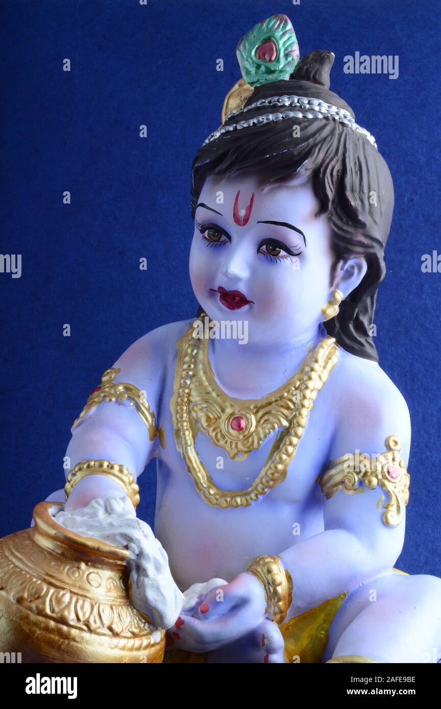 Hindu God Krishna on blue background Stock Photo - Alamy