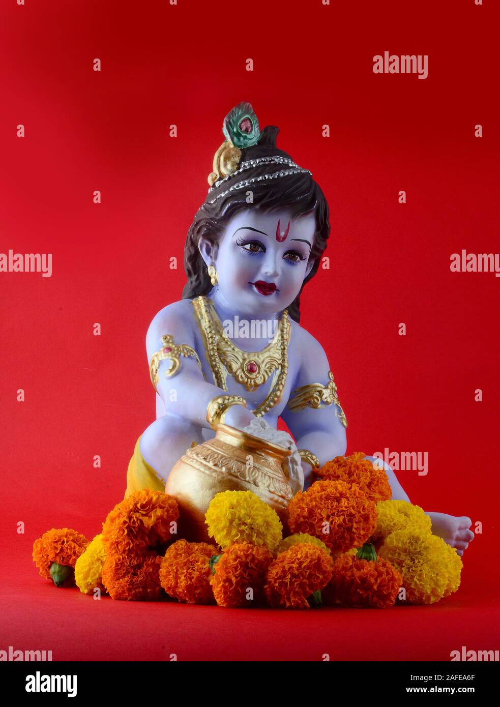 Hindu God Krishna on red background Stock Photo - Alamy
