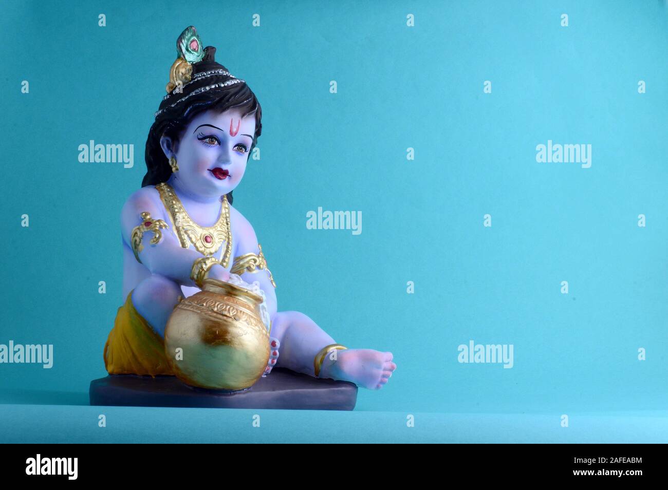 Hindu God Krishna on blue background Stock Photo - Alamy