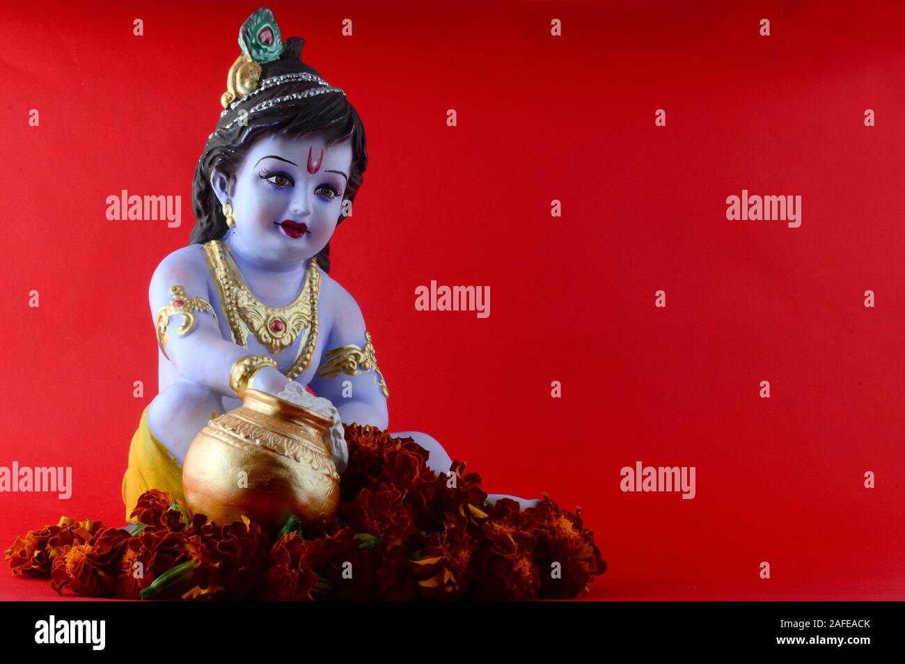 Hindu God Krishna on red background Stock Photo - Alamy