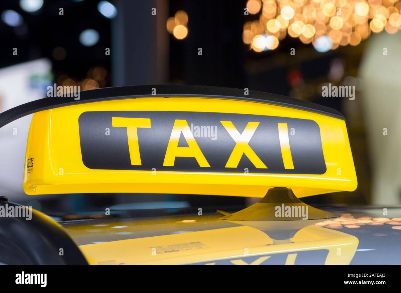 Taxi waiting for ride. Taxi sign on top of car Stock Photo - Alamy