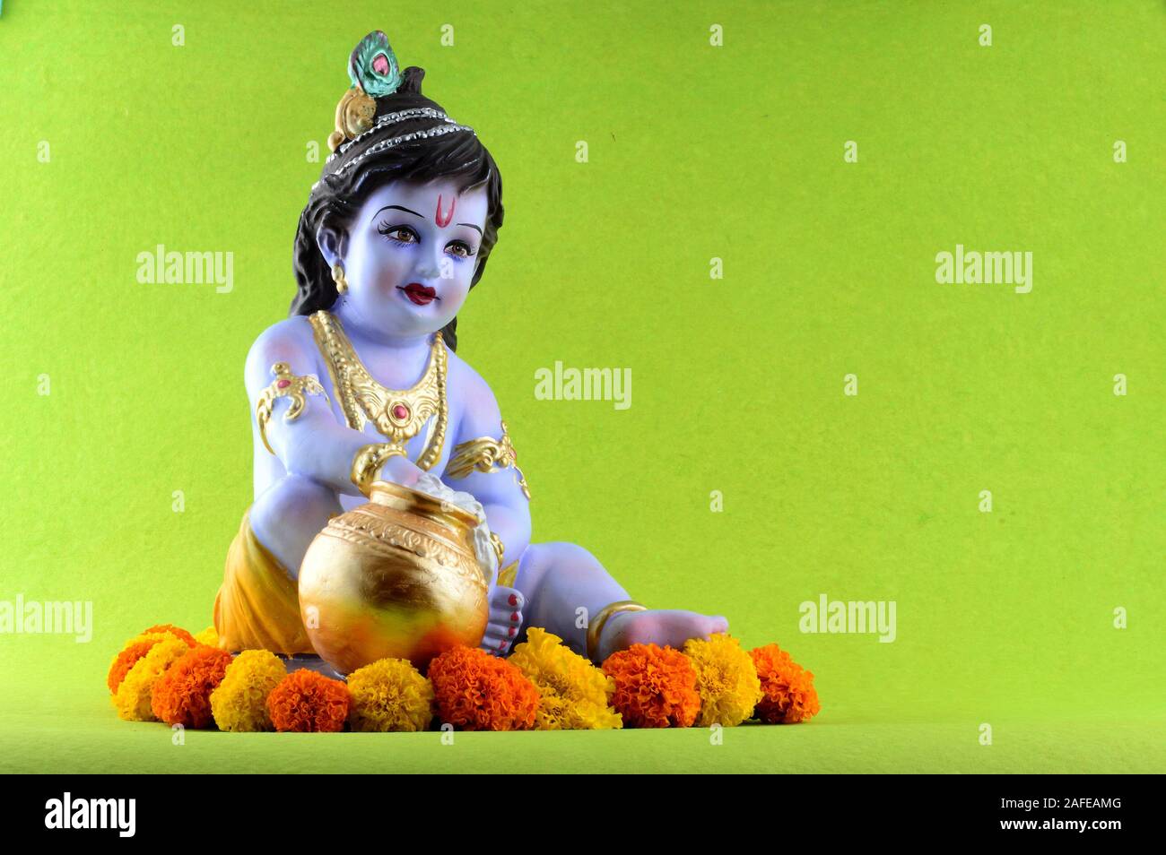 Hindu God Krishna on green background Stock Photo - Alamy