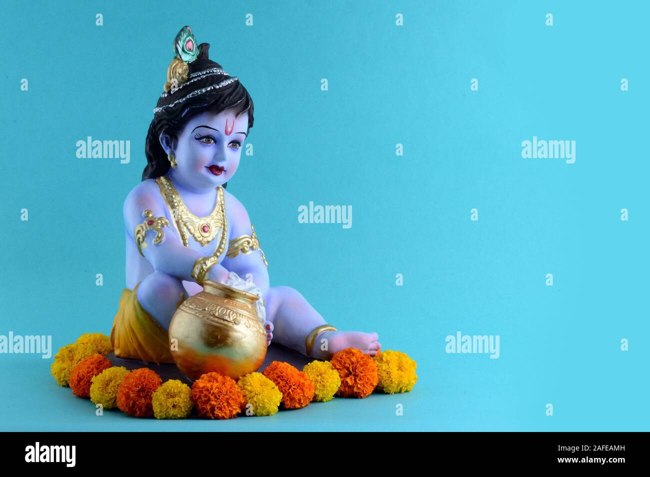 Hindu God Krishna on blue background Stock Photo - Alamy