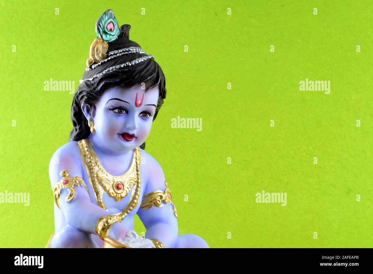 Hindu God Krishna on green background Stock Photo - Alamy