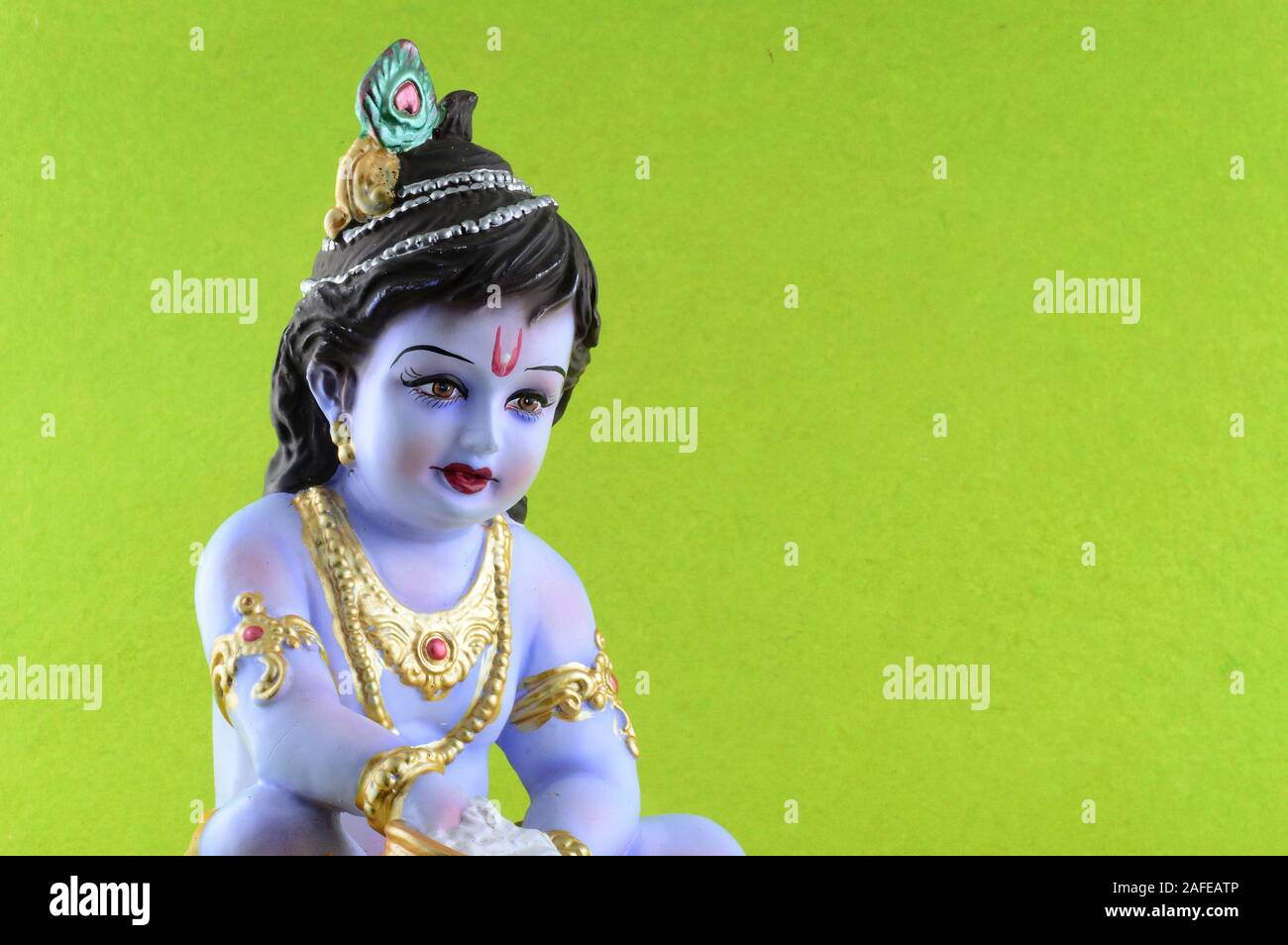 Hindu God Krishna on green background Stock Photo - Alamy