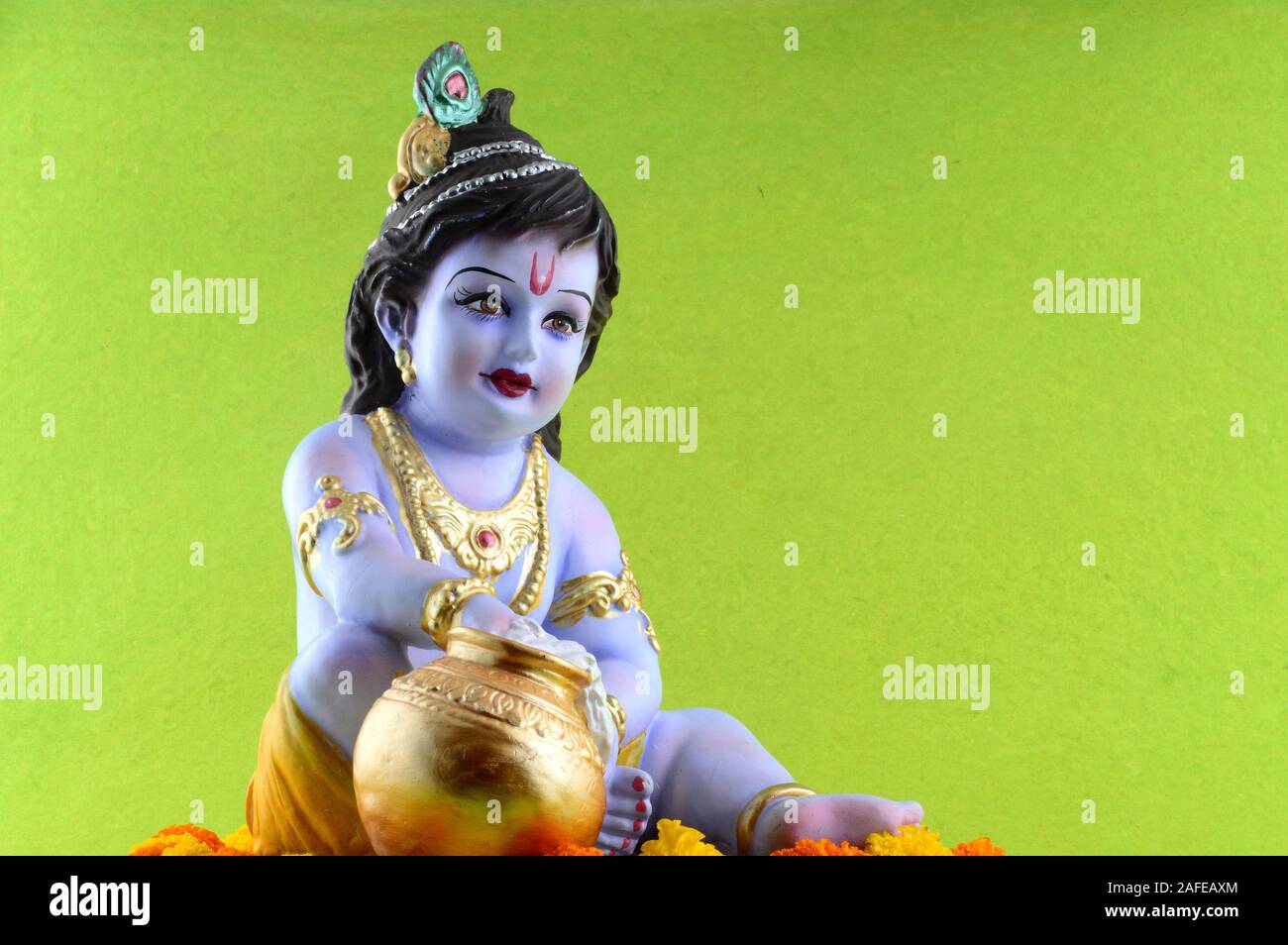Hindu God Krishna on green background Stock Photo - Alamy