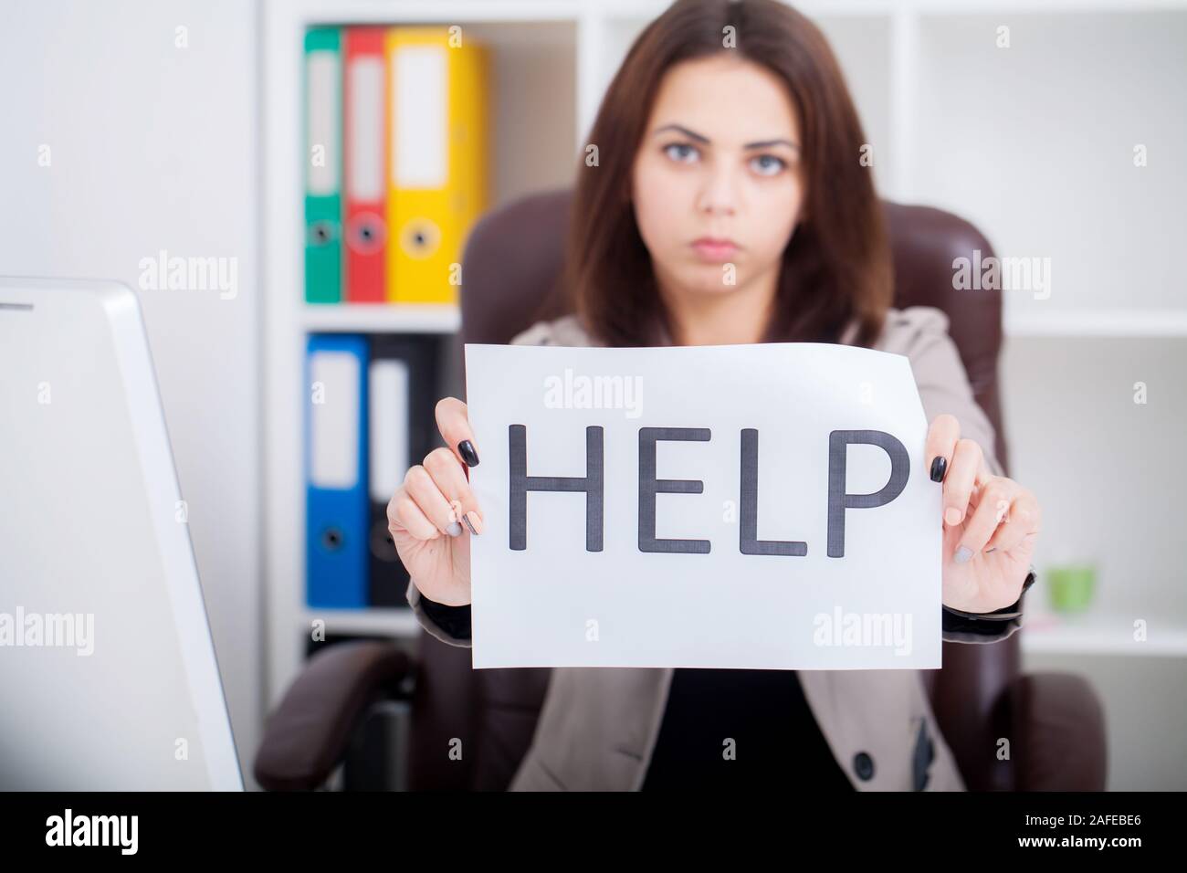 Stressed business woman imploring for help, holding a cardboard with ...