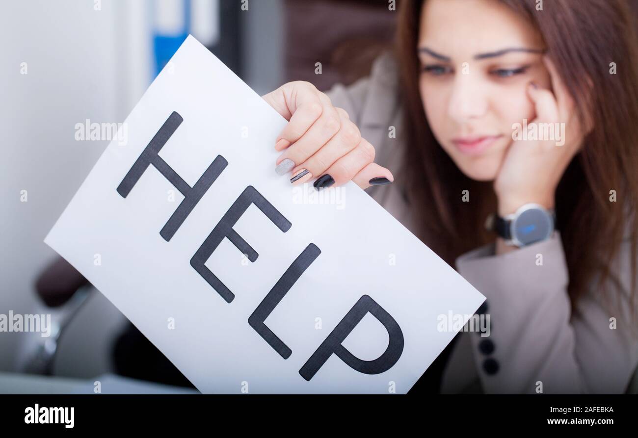 Close up girl hand putting signature on document. She situating at desk ...