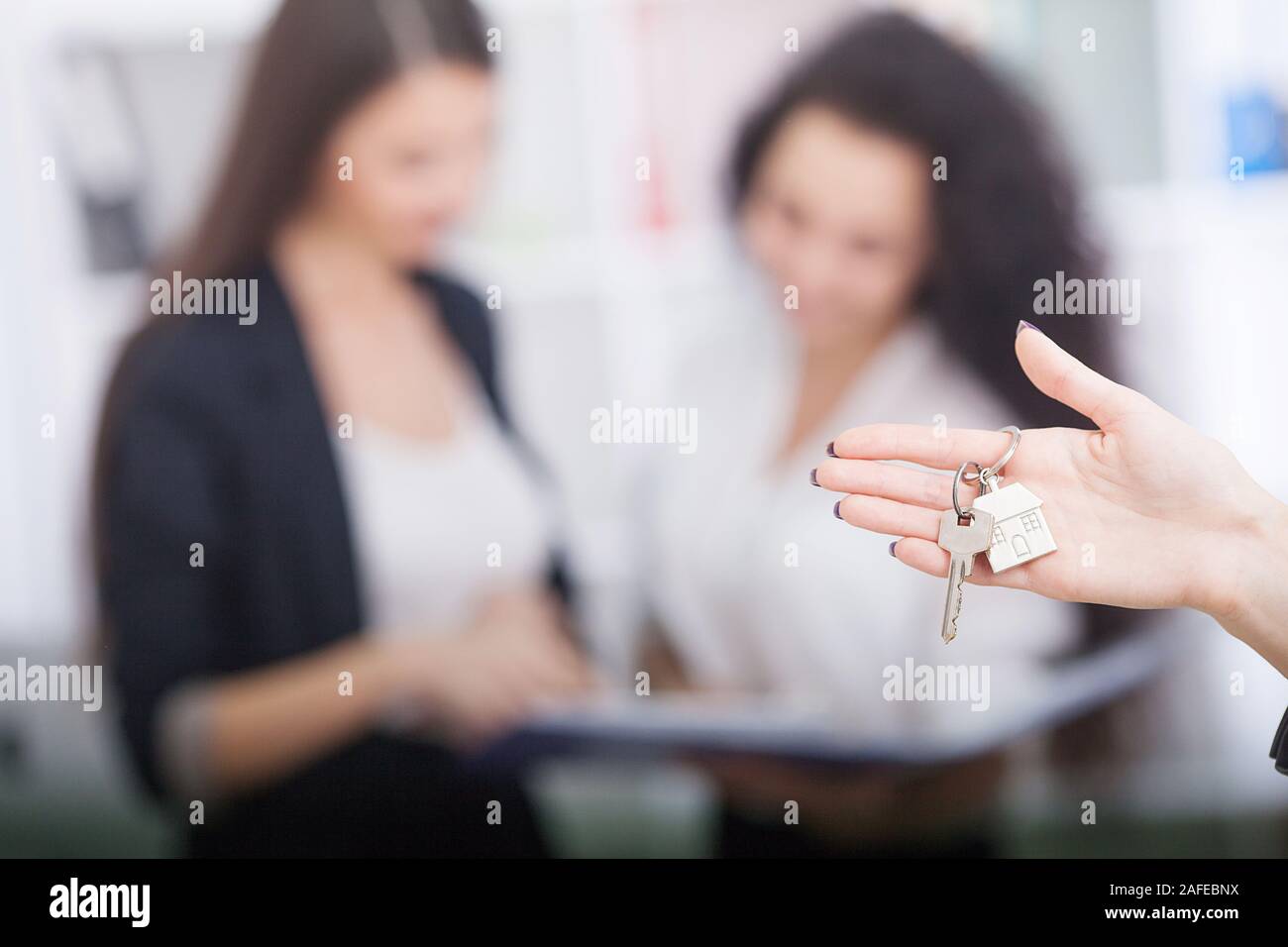 Real estate agent giving house keys to a customer Stock Photo - Alamy