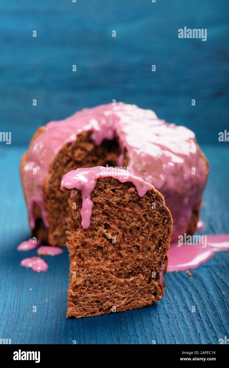 Homemade chocolate panettone with sugar icing on blue background ...