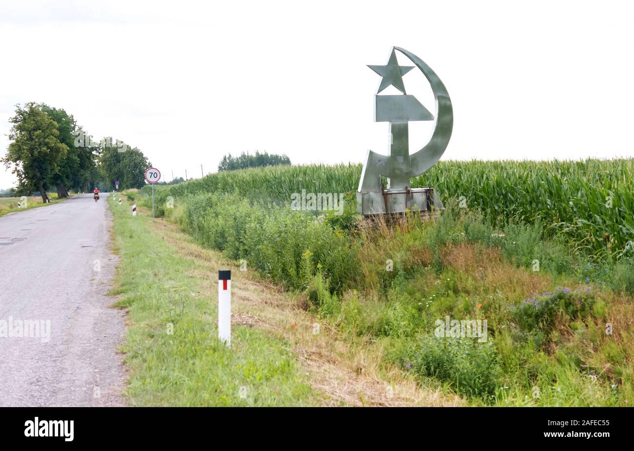 a symbol of the Soviet era by the road, hammer and sickle of the Soviet ...