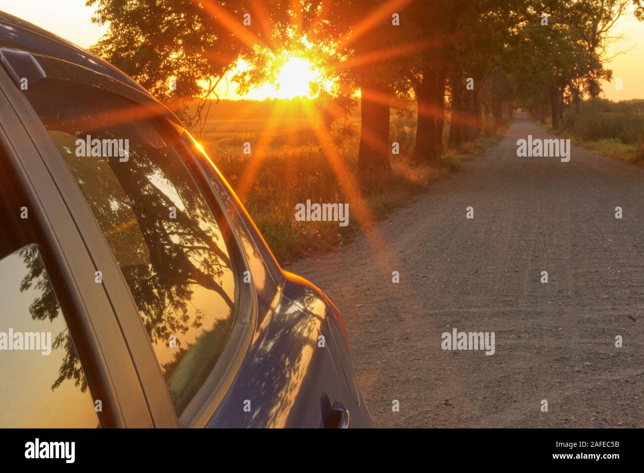 the sunset and the car, the sun's rays blue cars on the road Stock ...