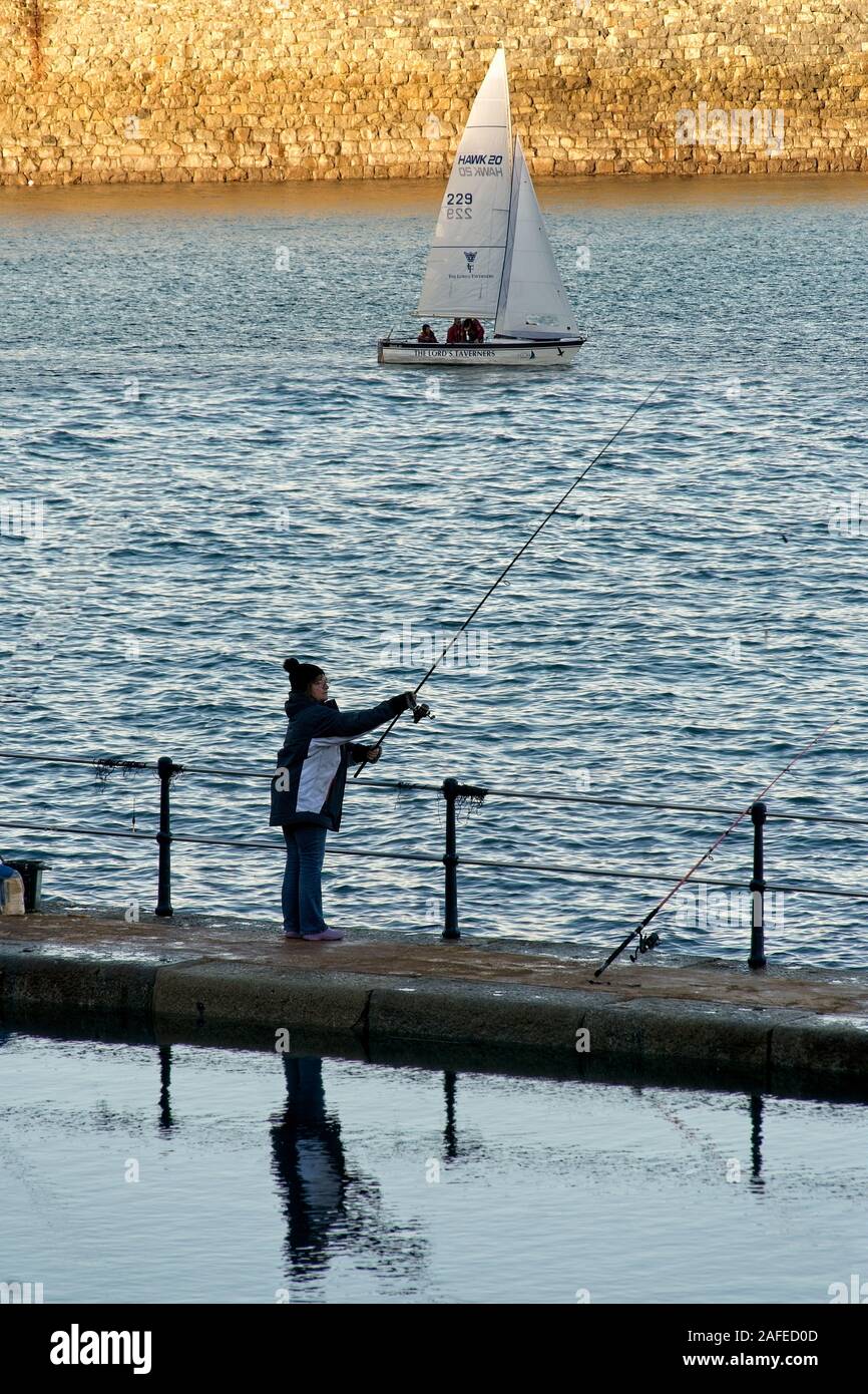 Angler fishing from outdoor sea water swimming pool Stock Photo - Alamy