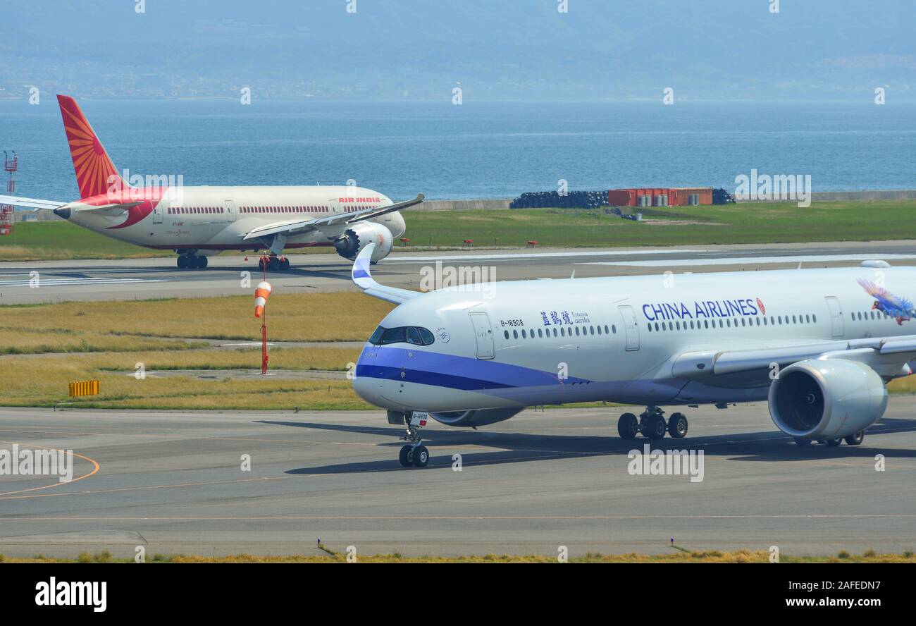 Osaka, Japan - Apr 18, 2019. Passenger airplanes taxiing on runway of ...