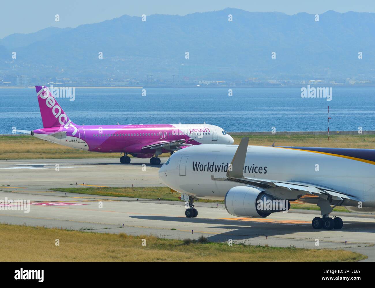Osaka, Japan - Apr 18, 2019. Passenger airplanes taxiing on runway of ...