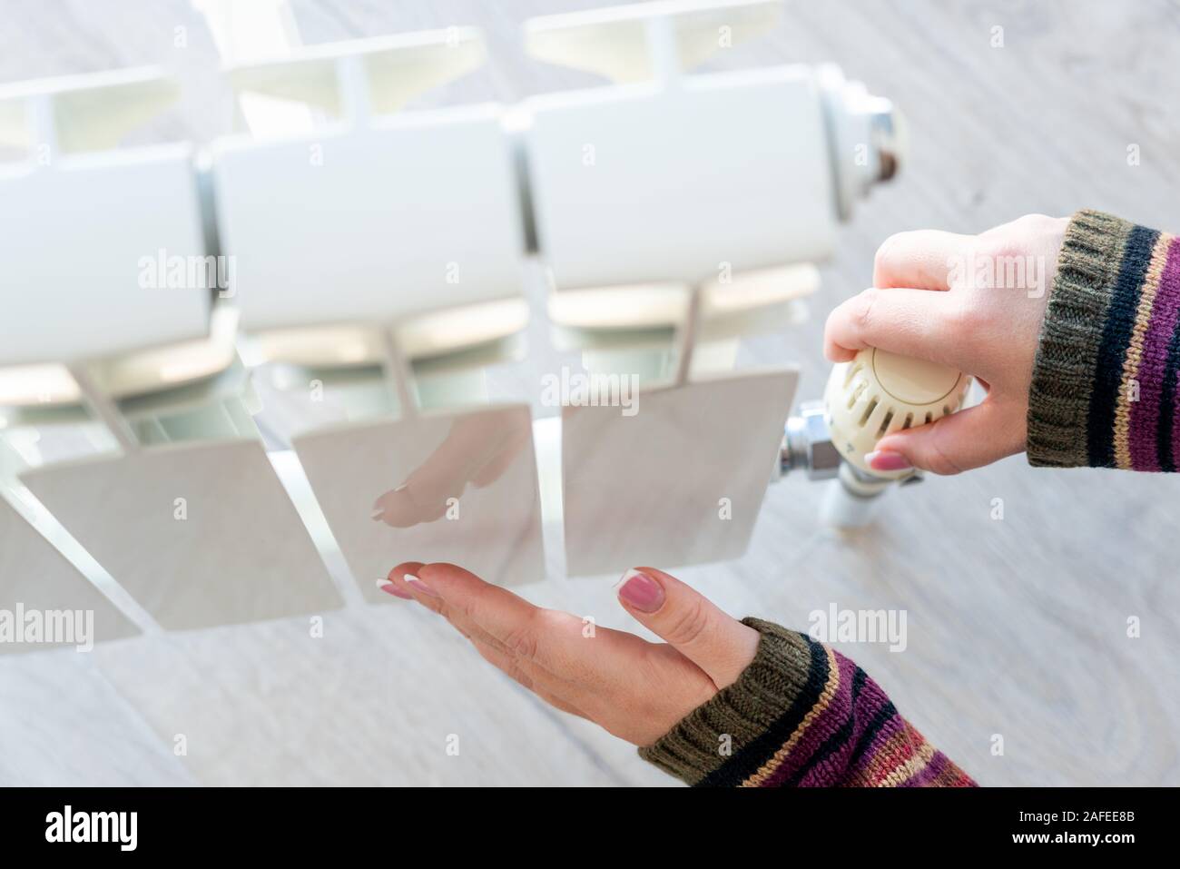 Radiator adjustment closeup, Female hand adjusting radiator temperature ...