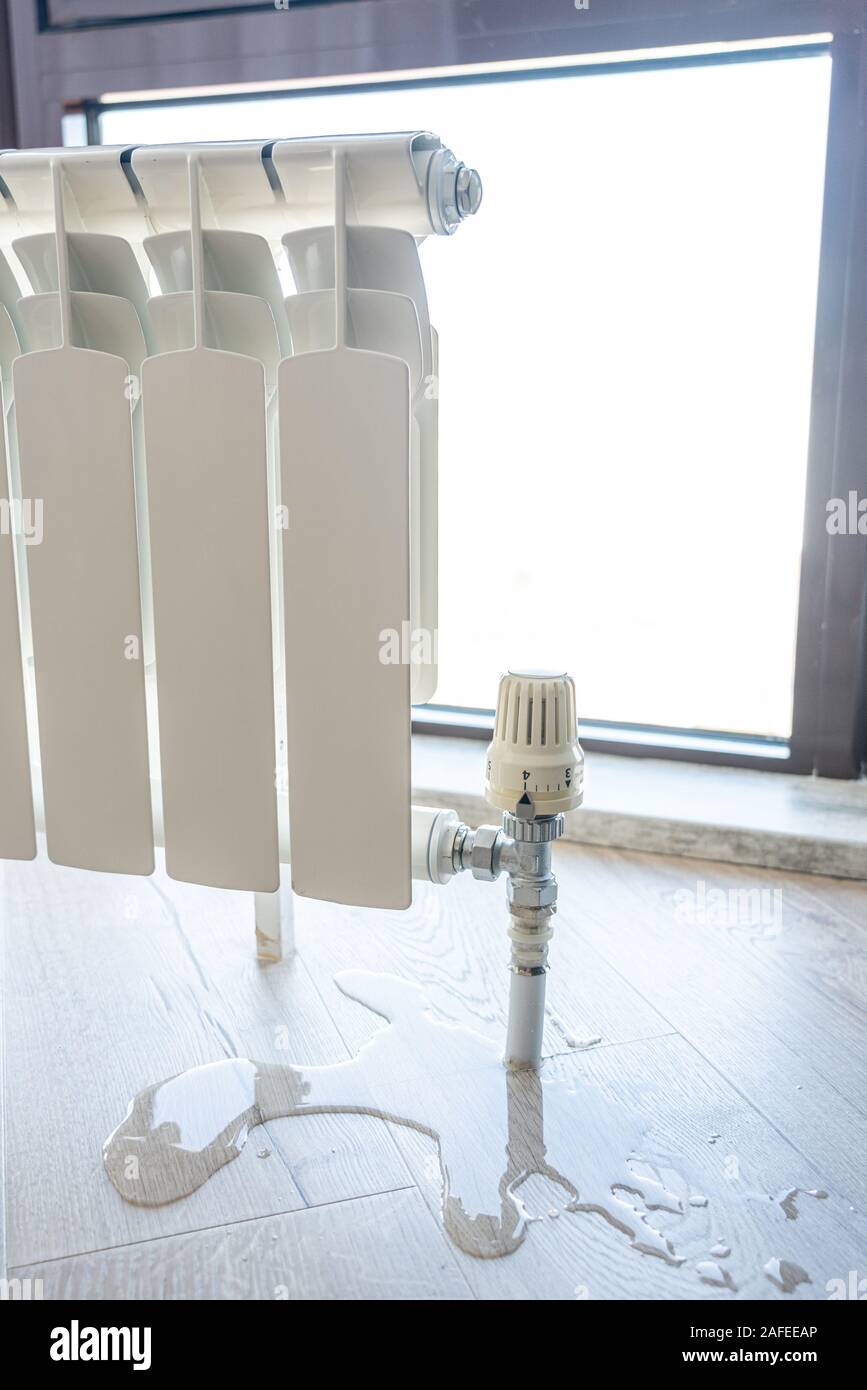 water leak through the heating radiator tube nut Stock Photo - Alamy