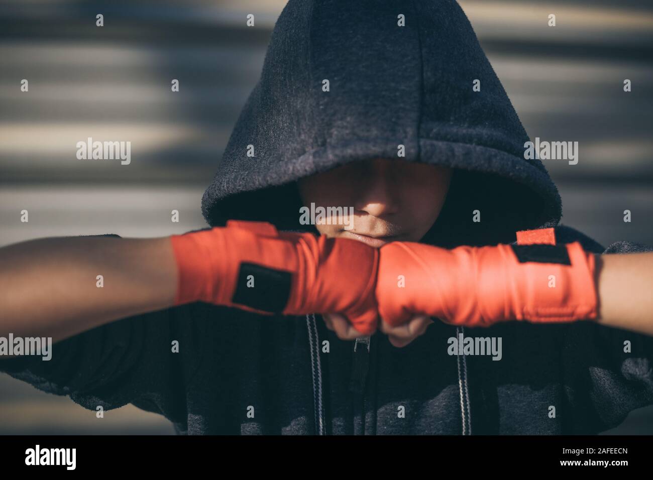 Young male hands with boxing bands ahead the face. Boy prepares for a ...