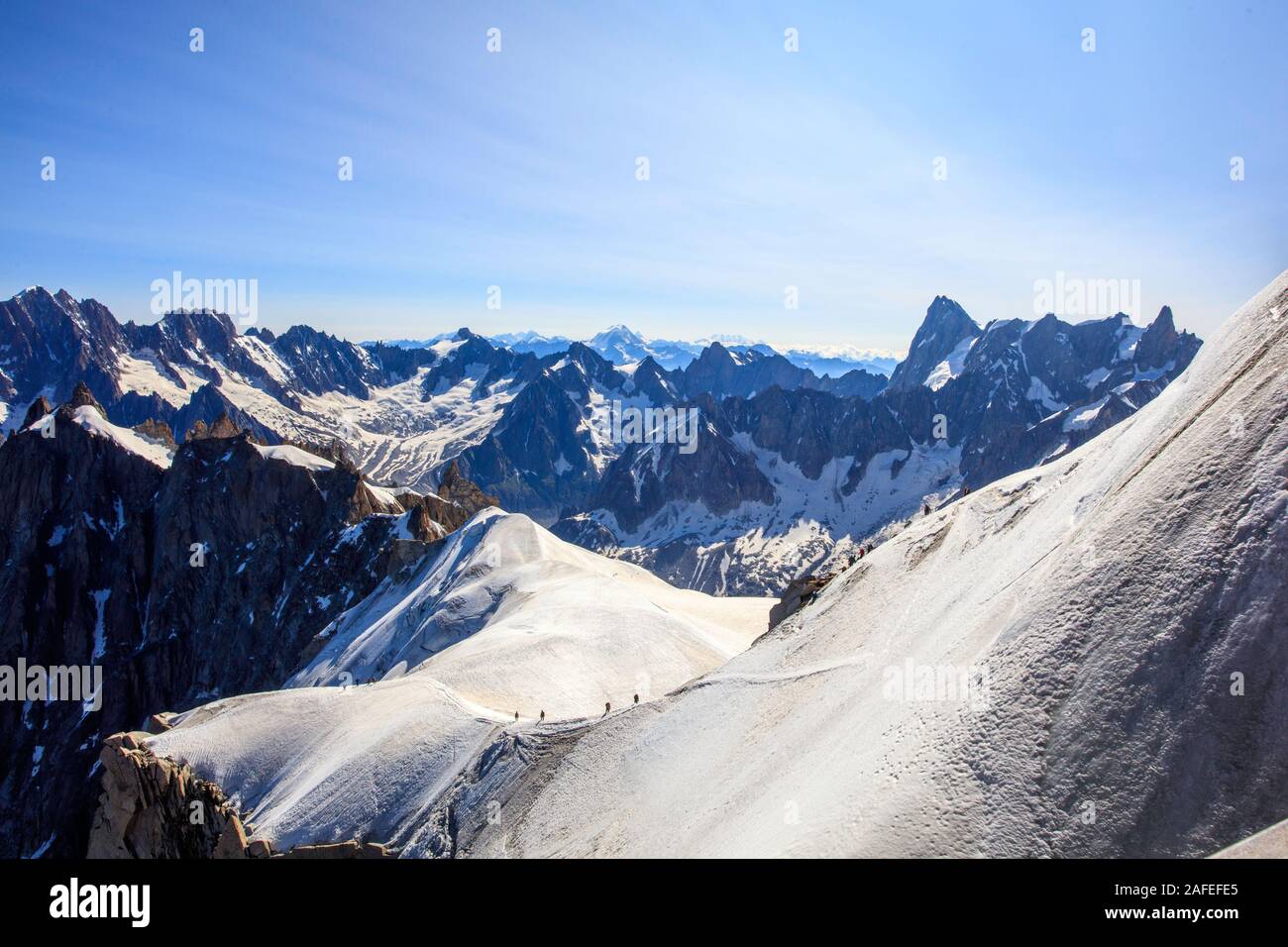 Mountaineers from a distance climb to reach the Mont Blanc summit ...