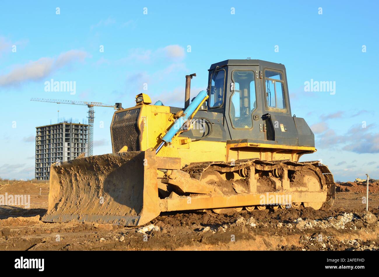 Bulldozer during of large construction jobs at building site. Land ...